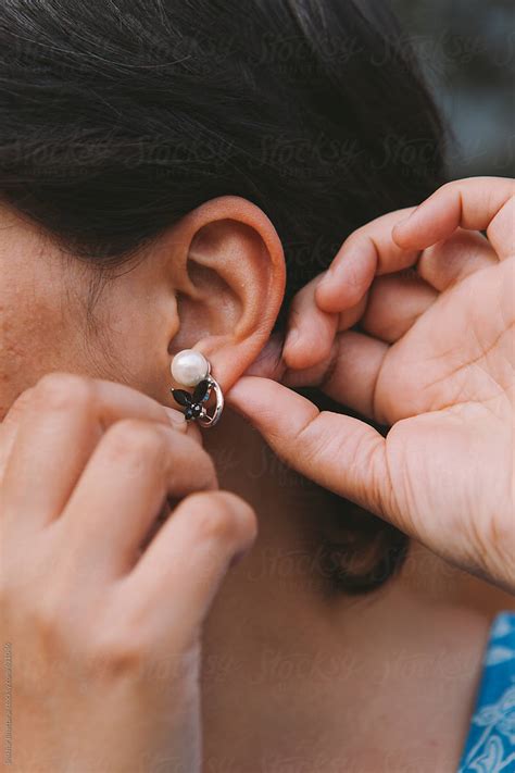 Putting On A Earring By Stocksy Contributor Shikhar Bhattarai
