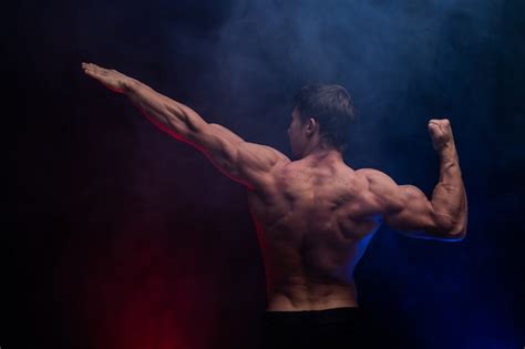 Premium Photo Muscular Man Showing Muscles Isolated On The Black