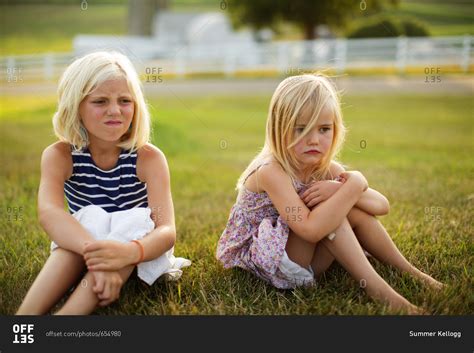 Girls Sitting In Grass Offset Stock Photo OFFSET