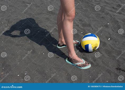 Jeune Fille De Jambes Nues Sur La Plage Et La Boule De Sable Image