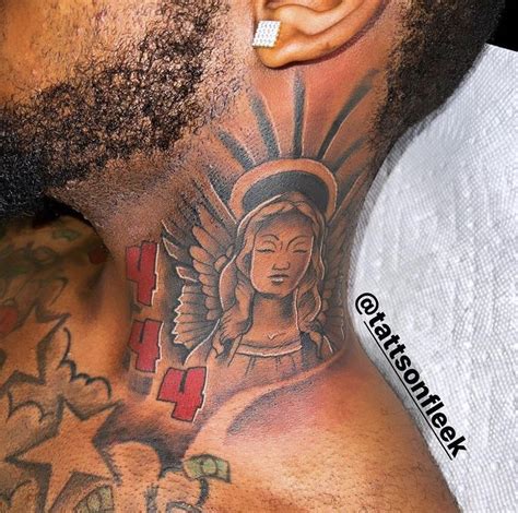 A Man With A Tattoo On His Neck
