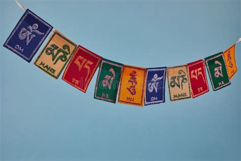 Tibetan Buddhist Flags Against Blue Background Text On Flags Om Mani