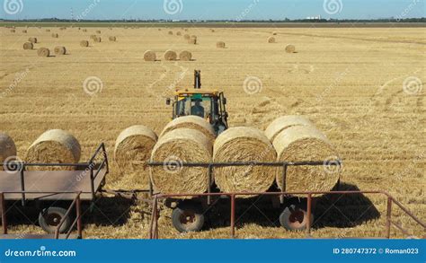 Aerial View Of Agricultural Field Collecting Round Bales Of Straw