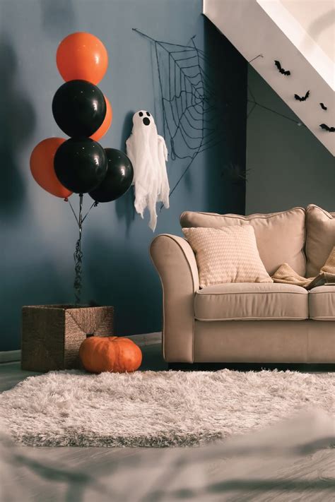 A Living Room Decorated For Halloween With Balloons And Pumpkins On The