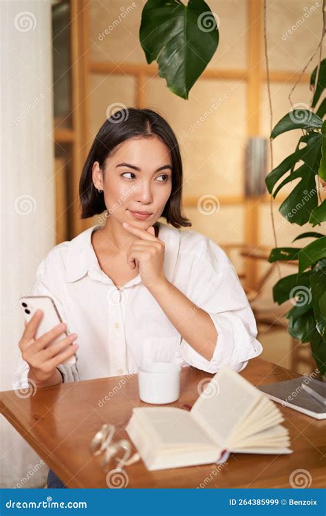 Beautiful Young Woman 25 Years Old Thinking Holding Smartphone And Looking Thoughtful