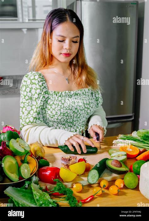 Asian Girl Cooking Healthy Vegetarian And Vegan Food Vegetables And Fruits In The Kitchen