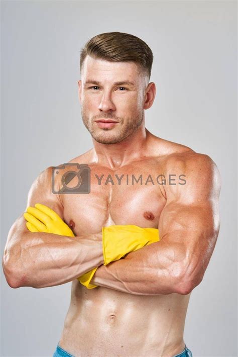 Man With A Pumped Up Naked Body In Rubber Gloves Gesture With His Hands