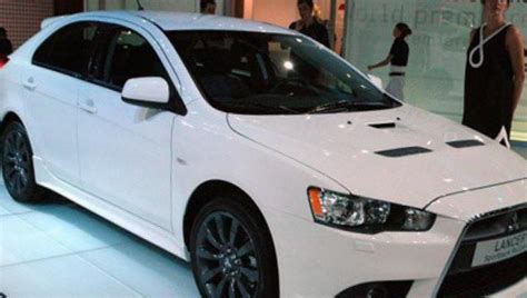 A White Car Is On Display At An Auto Show