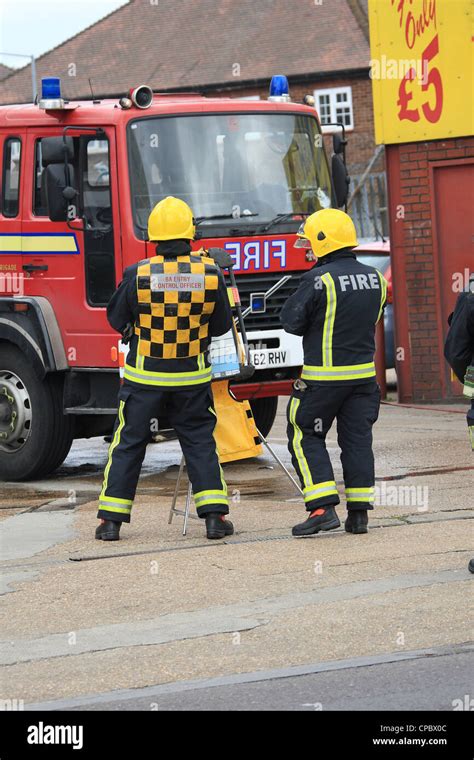 London Fire Brigade Firefighters At BA Control Point During A Fire In