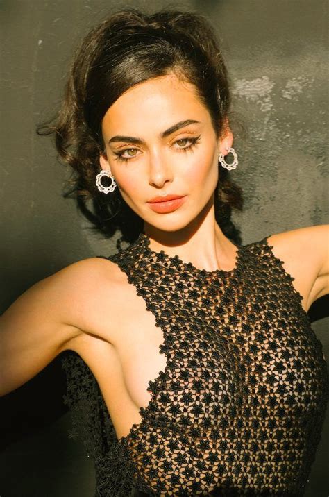 A Woman In A Black Dress Posing For The Camera