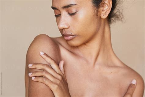 Girl Hydrating Body With Her Eyes Closed By Stocksy Contributor