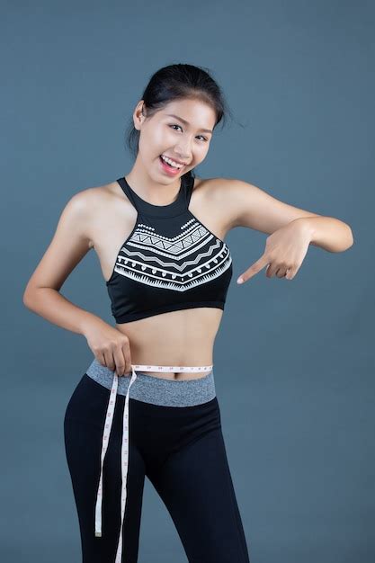 Free Photo Women In Sportswear Hold A Waist Line