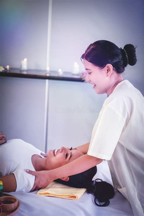 Female Masseur Giving Asian Female A Thai Back Massage In Thai Relaxing Spa Therapy Stock Image
