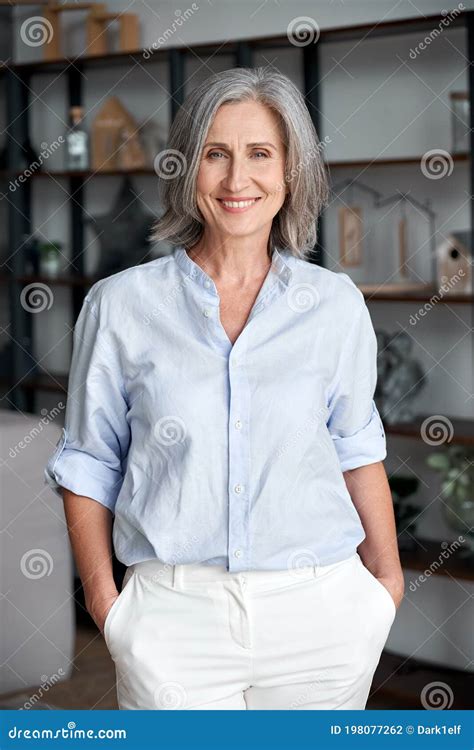 Smiling Elegant Confident Middle Aged Woman Standing In Office