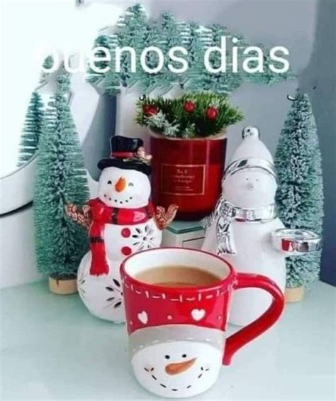 A Cup Of Coffee Sitting On Top Of A Table Next To Snowman Figurines