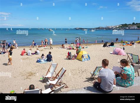 Visitors Flock To The Sandy Beaches At Swanage Making The Best Of The