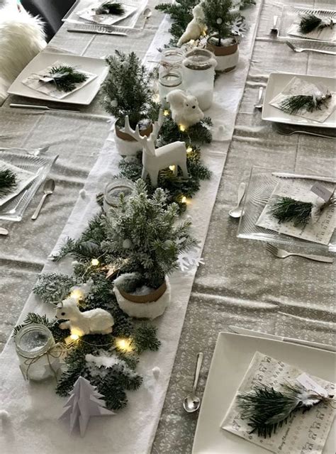 The Table Is Set With Silverware And White Napkins Decorated With