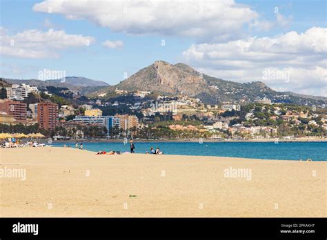 Playa La Malagueta Beach With The Monte Malaga Mountains Behind People