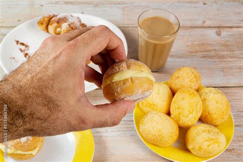 Male Hand Picking Up Food From A Brazilian Snacks Table Cheese Bread Sweet Brioche Latte And