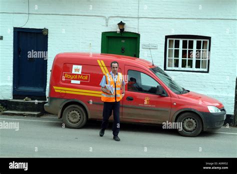 Postman Delivers Letters In Rural Location England UK Royal Mail Stock