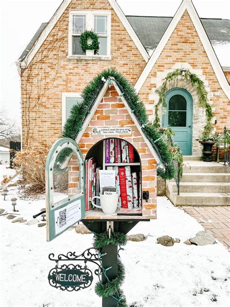 A Mailbox Is Decorated With Christmas Wreaths And Books In Front Of A