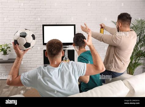 Group Of Friends Watching Football At Home Back View Stock Photo Alamy