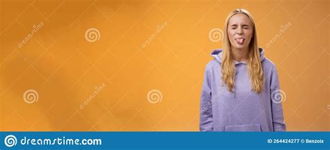 Playful Amused Charismatic Young Funny Blond Girl Having Fun Close Eyes Showing Tongue
