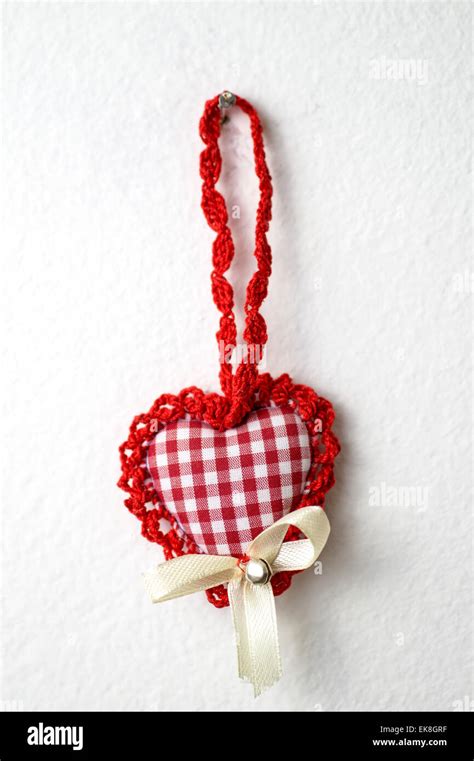 Handmade Knitted Heart Shape Hanging On The White Wall Stock Photo Alamy