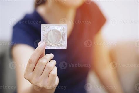 Condoms Ready To Use In Female Hand Give Condom Safe Sex Concept On The Bed Prevent Infection