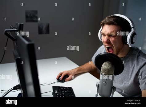 Man In Headset Playing Computer Video Game At Home Stock Photo Alamy