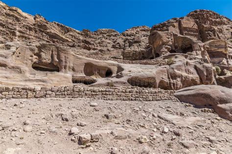 A View Of Cave Dwellings Beside The Royal Tombs In The Ancient City Of