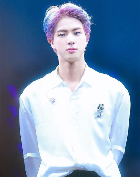 A Male In A White Shirt And Black Pants