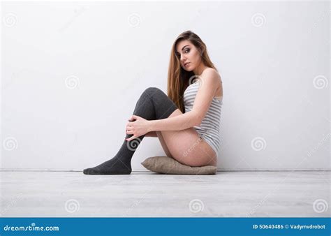 Side View Portrait Of A Woman Sitting On The Floor Stock Photo Image