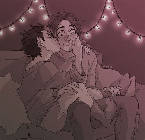 Two People Sitting On A Couch With Lights In The Background And One