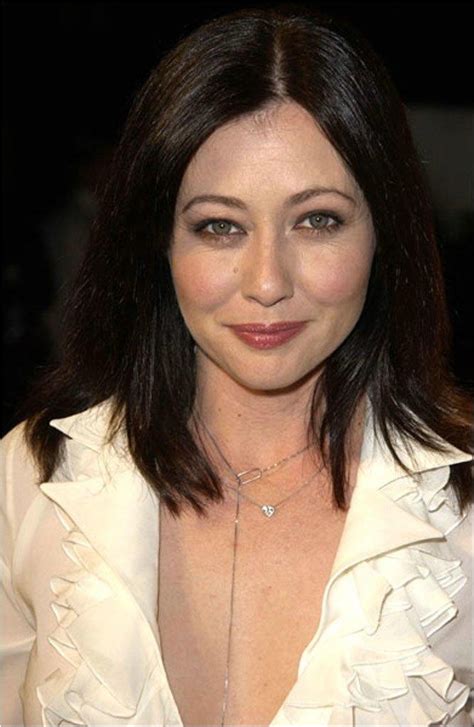 A Close Up Of A Person Wearing A White Shirt And Smiling At The Camera