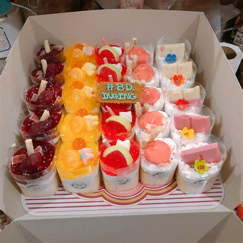 A Box Filled With Lots Of Different Types Of Cakes And Desserts On Top