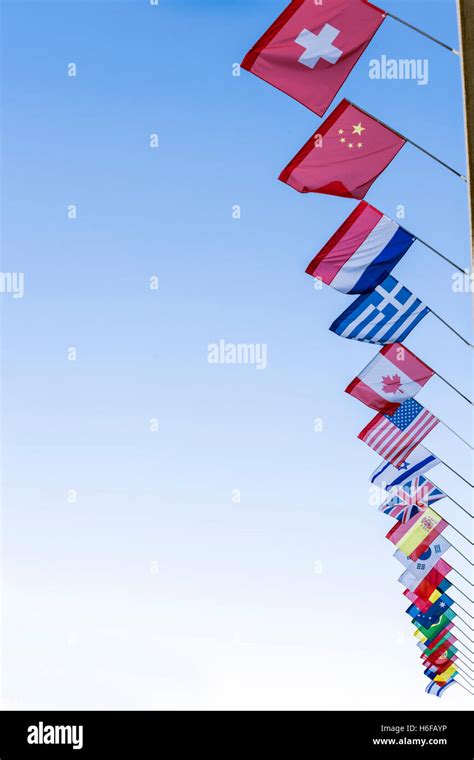 A Row Of Many National Flags Of Various Nations Fluttering In The Wind