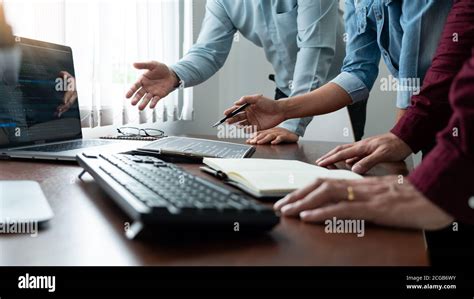 Team Of Programmer Working To Find Solution To Problem And Coding