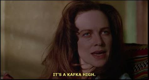 A Woman With Long Hair Sitting In A Chair Looking At The Camera And