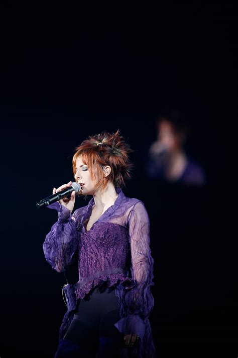 Mylène Farmer French singer redhead microphone violet dress