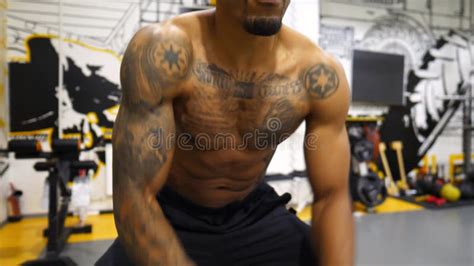 Muscular Afro American Sportsman Training With Battle Ropes In Fitness