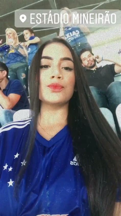 A Woman With Long Black Hair Sitting In Front Of A Group Of People