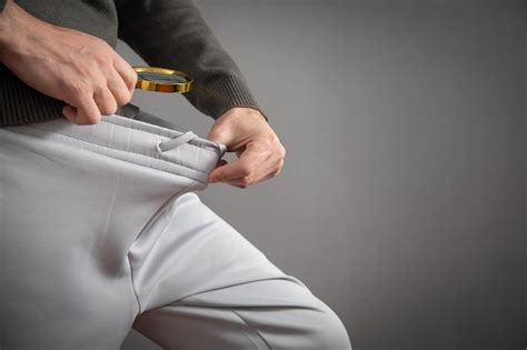 Premium Photo Man With A Magnifying Glass Looking His Penis