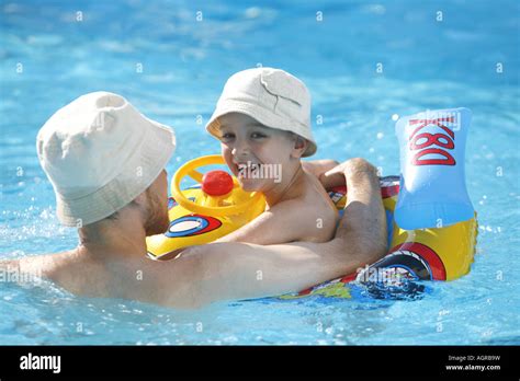 Father And His Son In Swimming Pool Summer Holiday Stock Photo Alamy