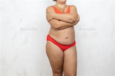 Naked Overweight Woman Stand In Closed Position Covering Breast By