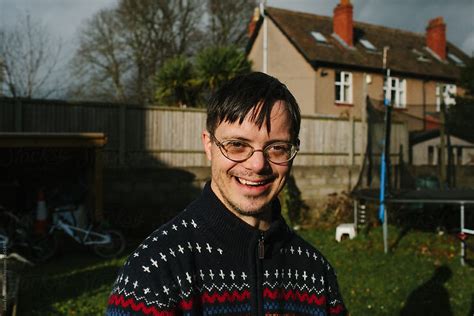A Happy Smiling Man With Down Syndrome In Garden By Stocksy