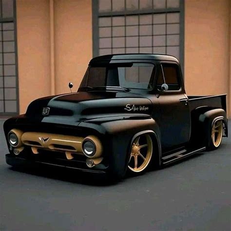 An Old Black Truck Parked In Front Of A Building