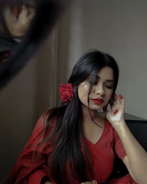 A Woman Sitting Down Talking On Her Cell Phone