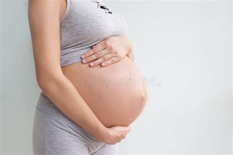 Close Up Of A Pregnant Belly A Pregnant Woman Holds Her Hands In Her