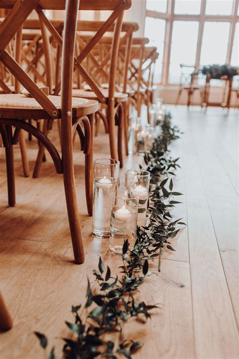Foliage Aisle Runner And Romantic Floating Candles In Glass Vases For A